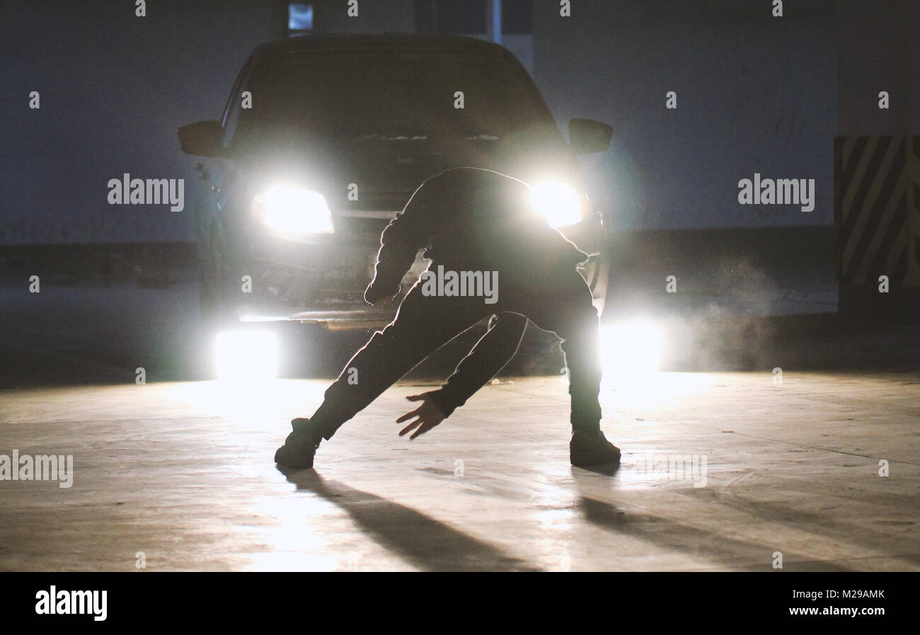 Teenager freerunner doing side flips in the garage, parkour acrobatic ...