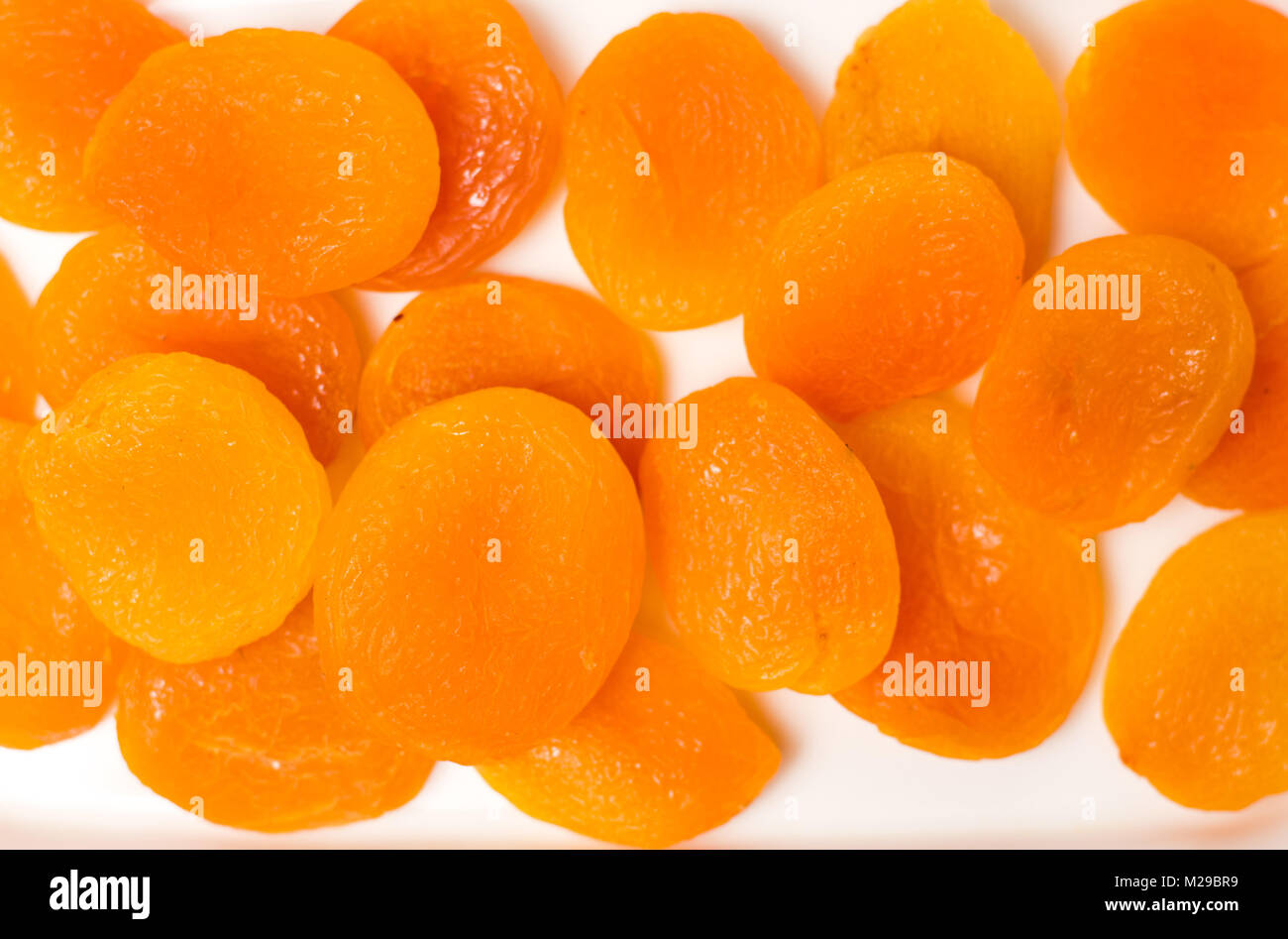 Dried apricot slices isolated on white background Stock Photo - Alamy