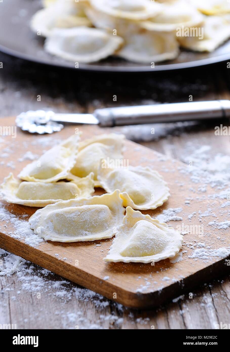 Preparing fresh ravioli at the kitchen table Stock Photo - Alamy