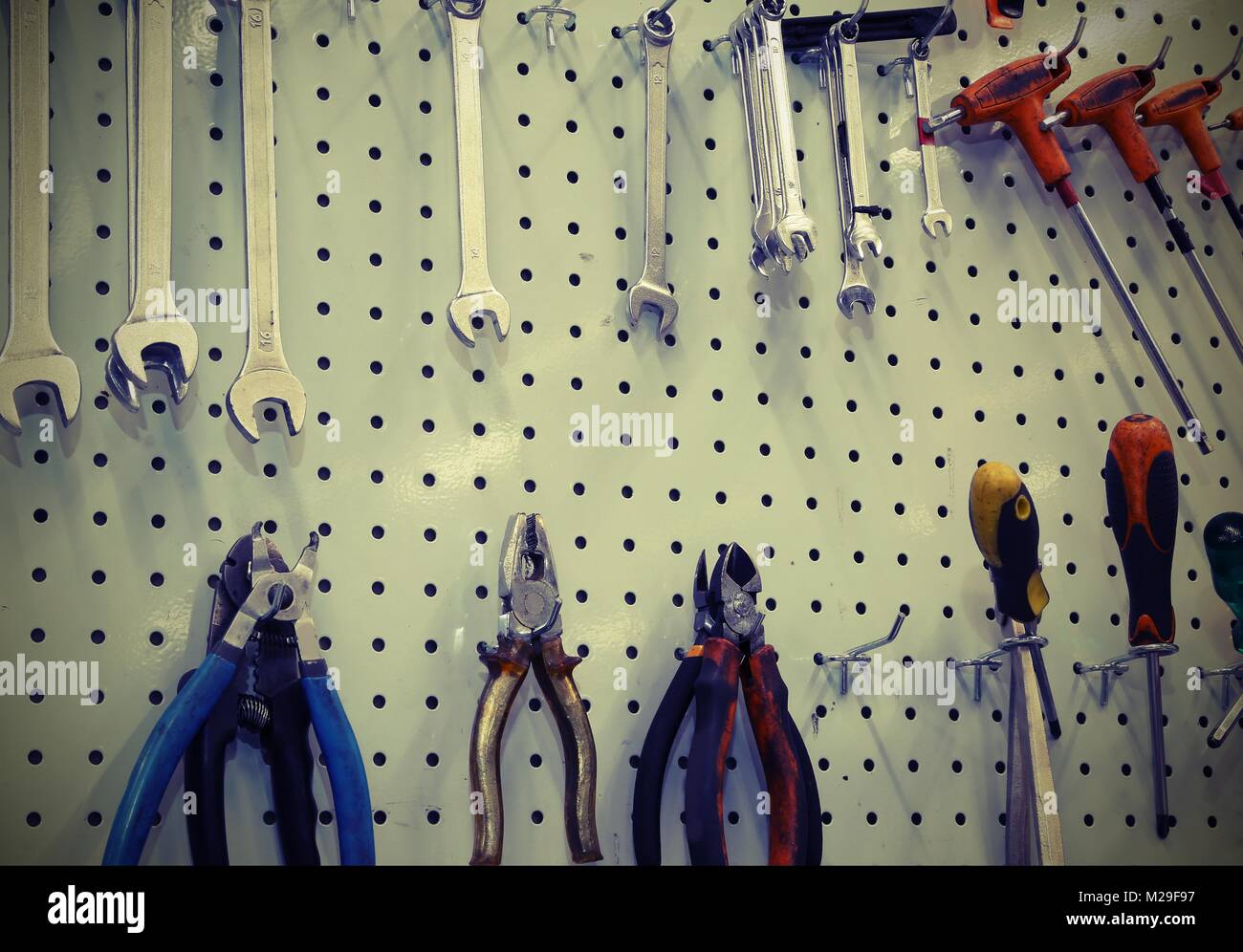 repair tools hung on the wall of a mechanical workshop with vintage ...