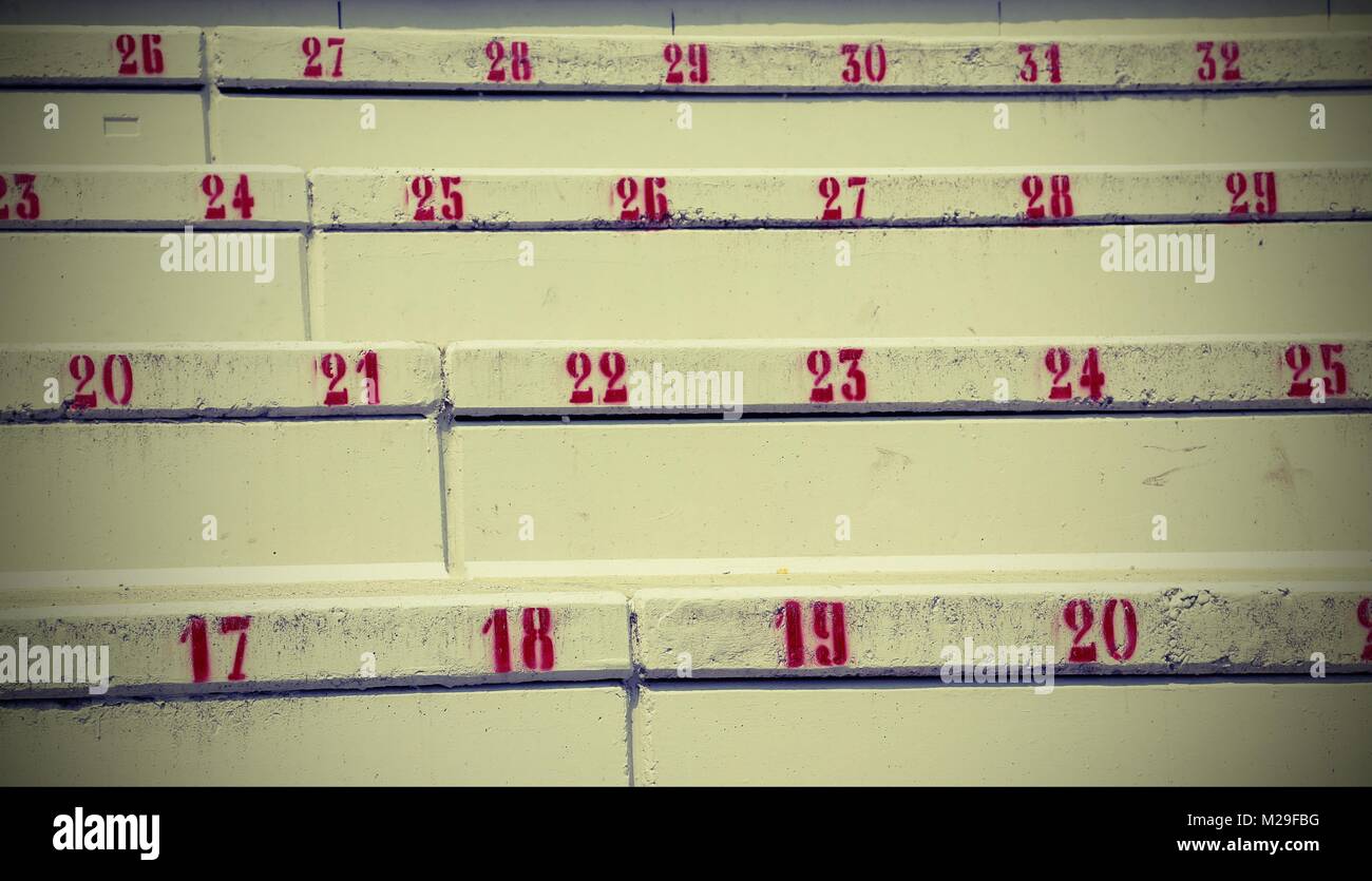 numbers on the stairs in the stadium to indicate the seat with vintage ...