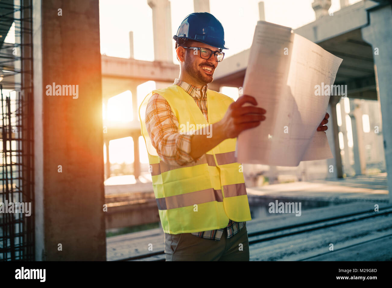 Picture of construction site engineer looking at plan Stock Photo - Alamy