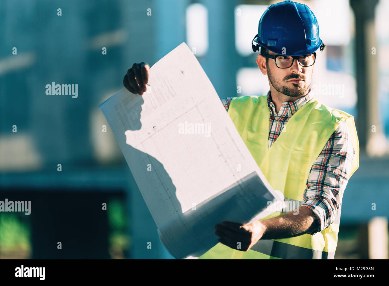 Picture of construction site engineer looking at plan Stock Photo - Alamy