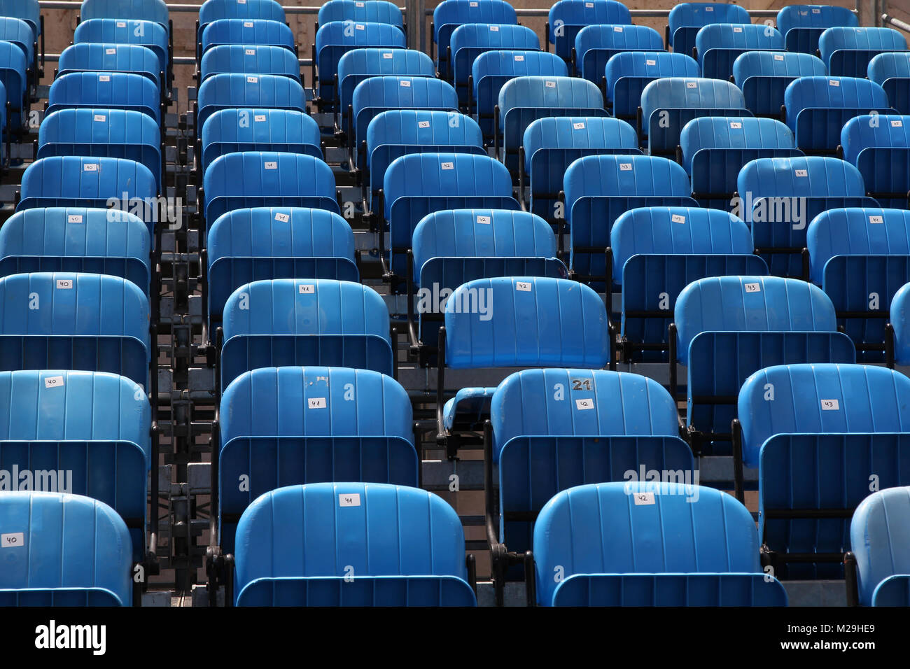 Blue rows of chairs at an outdoor concert. Audience seats Stock Photo ...