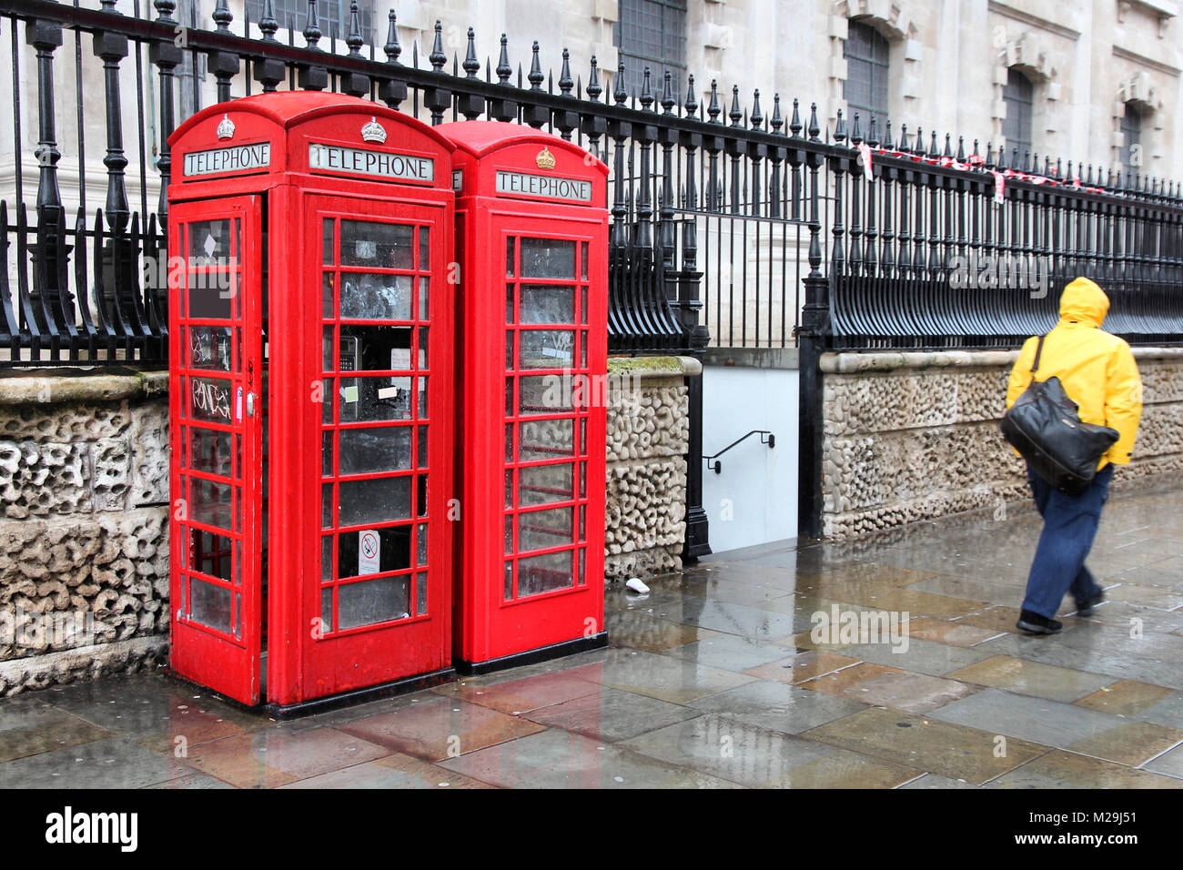 London, United Kingdom - red telephone boxes in wet rainy weather. Wet ...