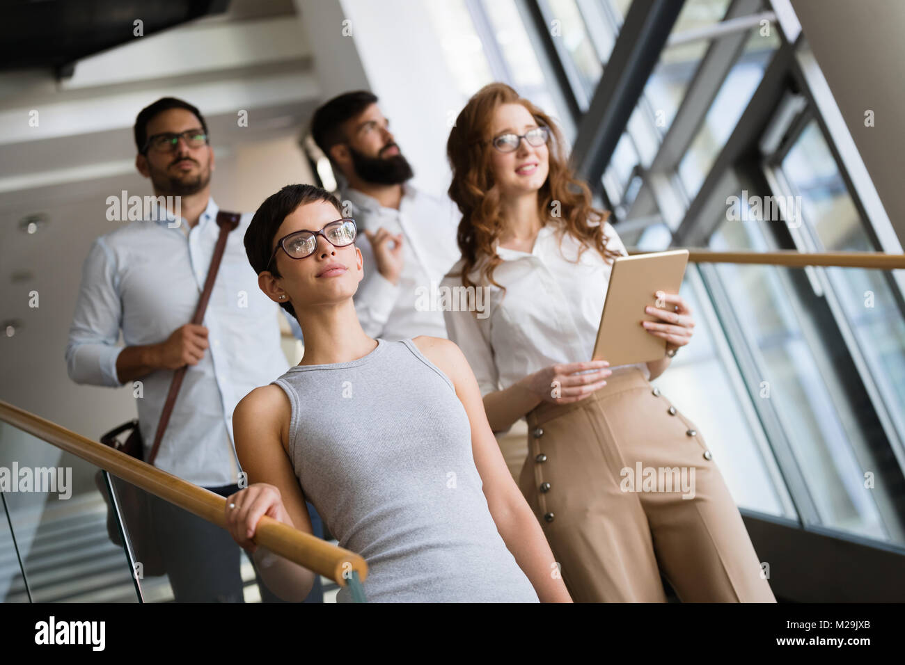 Group of young perspective businesspeople having discussion Stock Photo ...