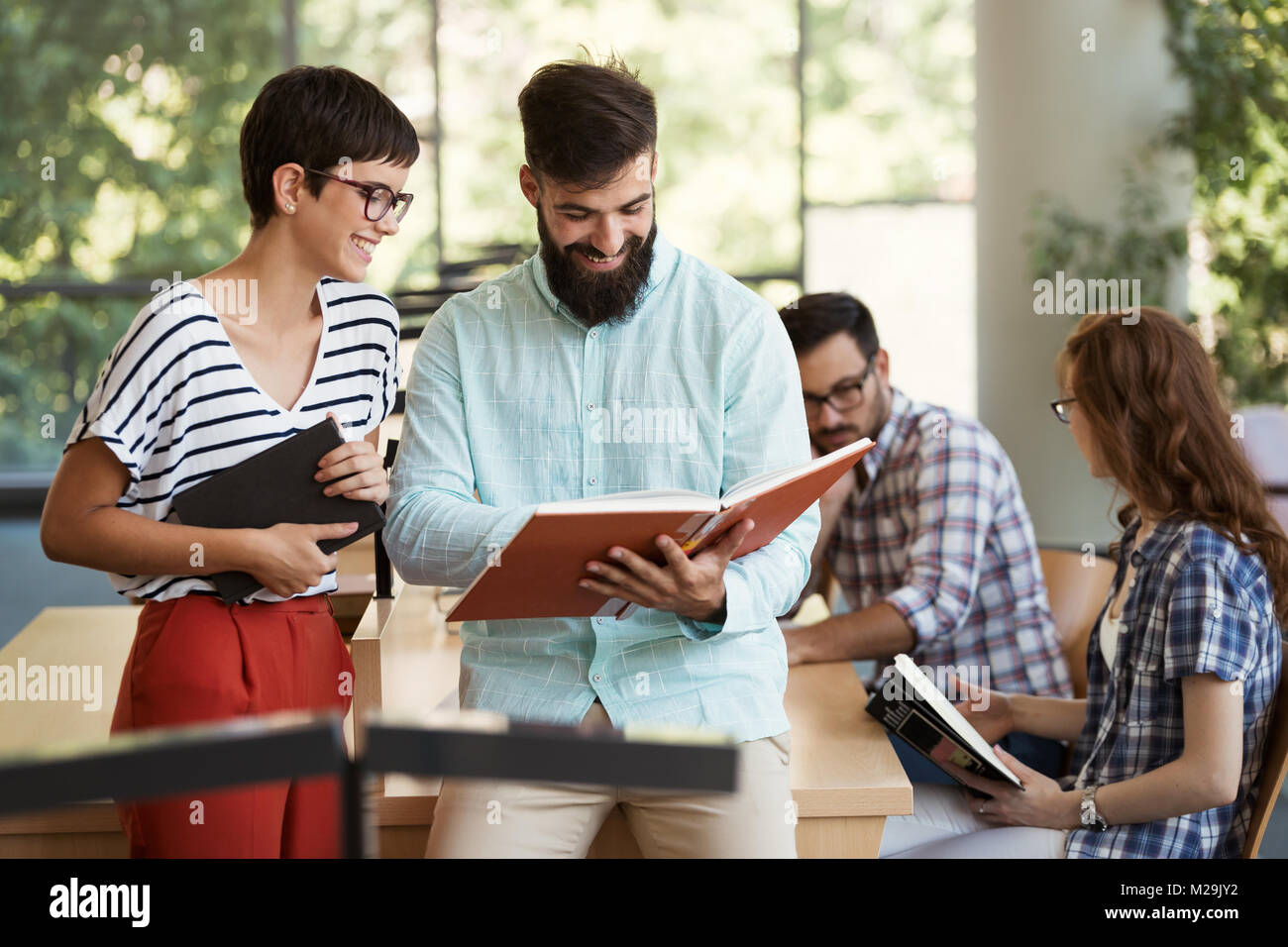 Group of young students studying together Stock Photo - Alamy