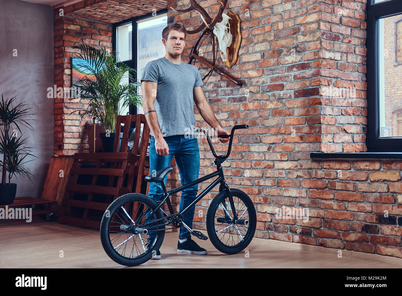 A handsome man with BMX in a studio Stock Photo - Alamy