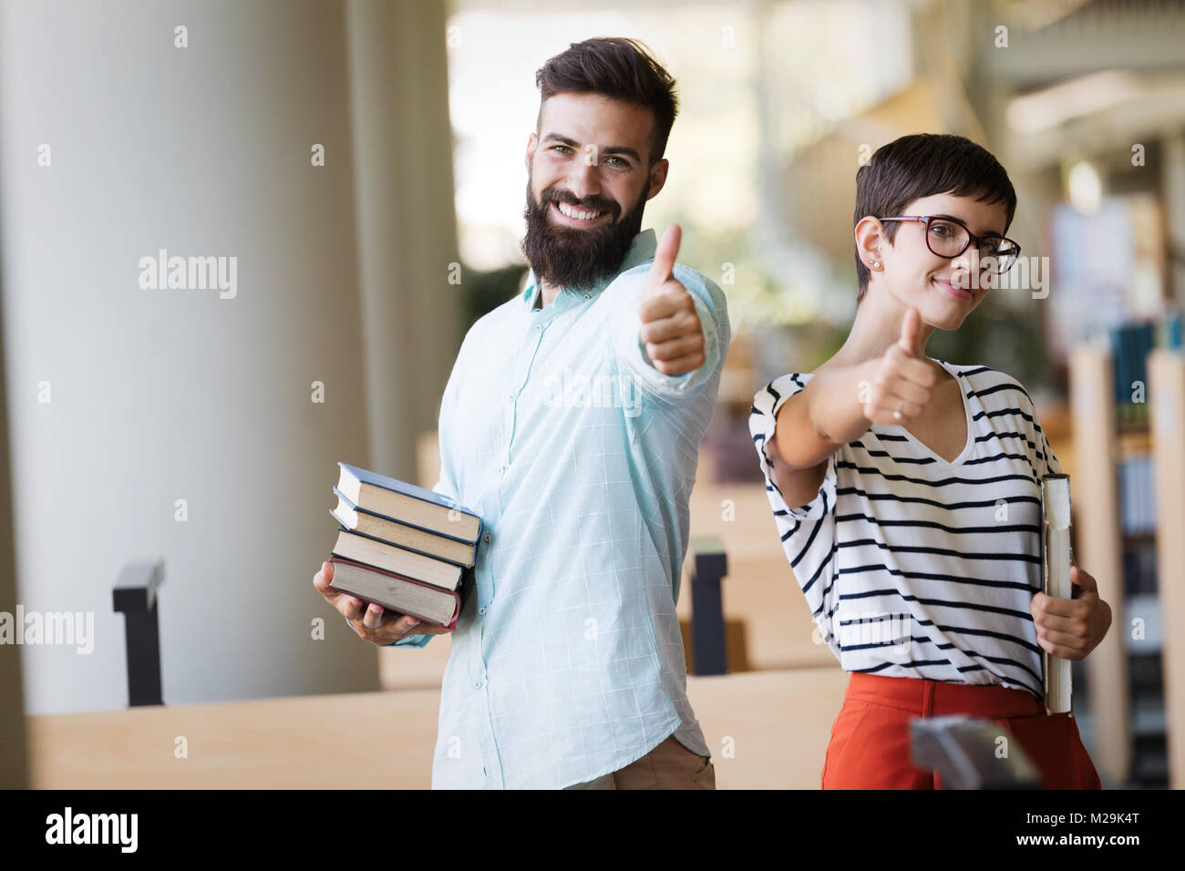 Young handsome men and attractive women are learning together and ...