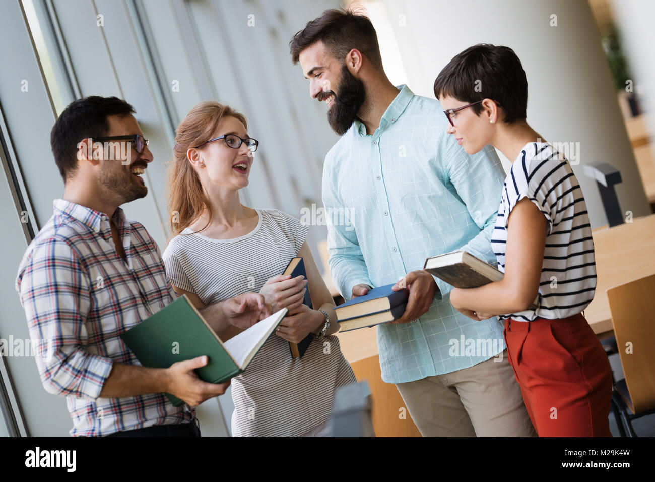 Group of young students studying together Stock Photo - Alamy