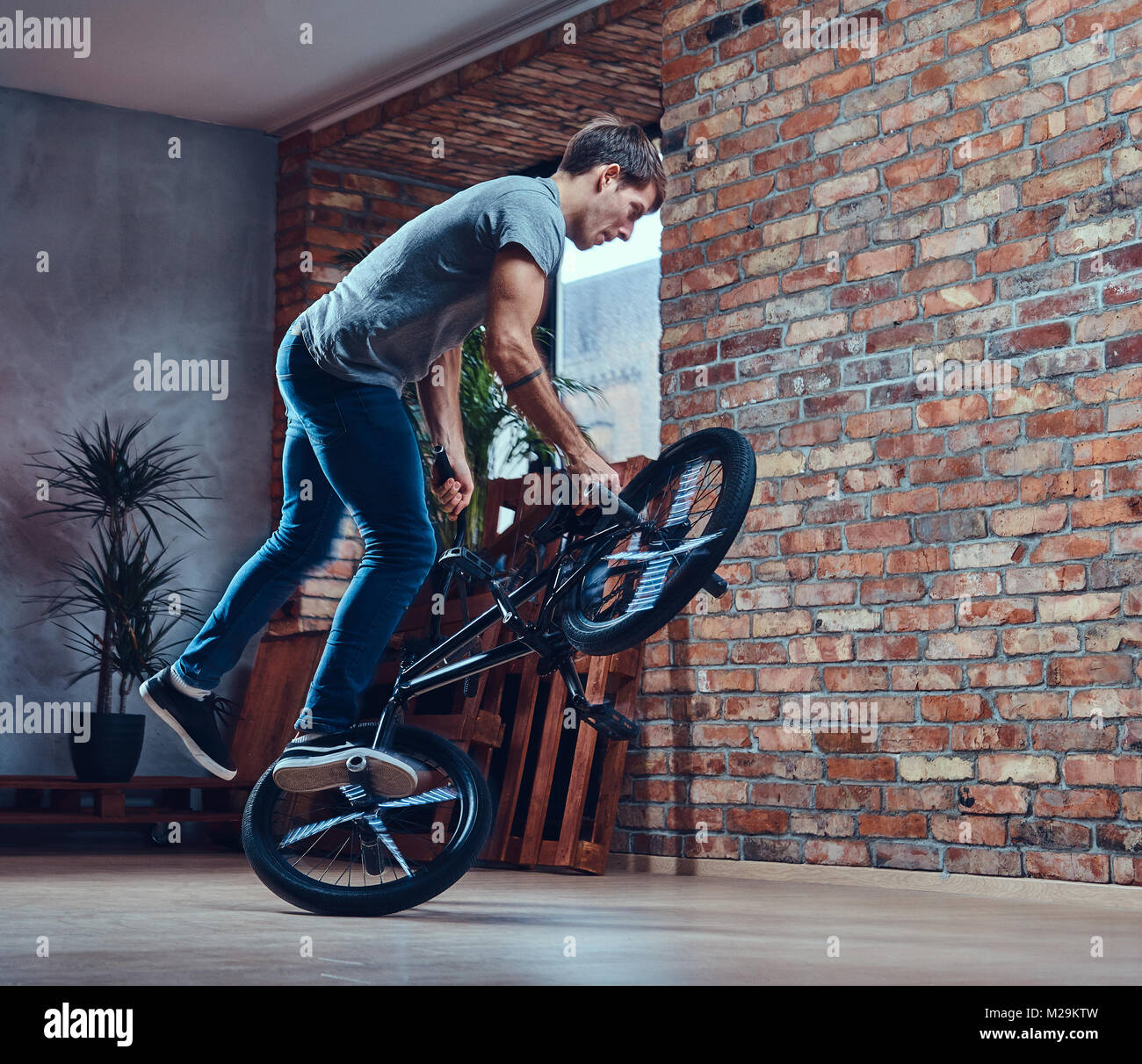 A handsome man with BMX in a studio Stock Photo - Alamy