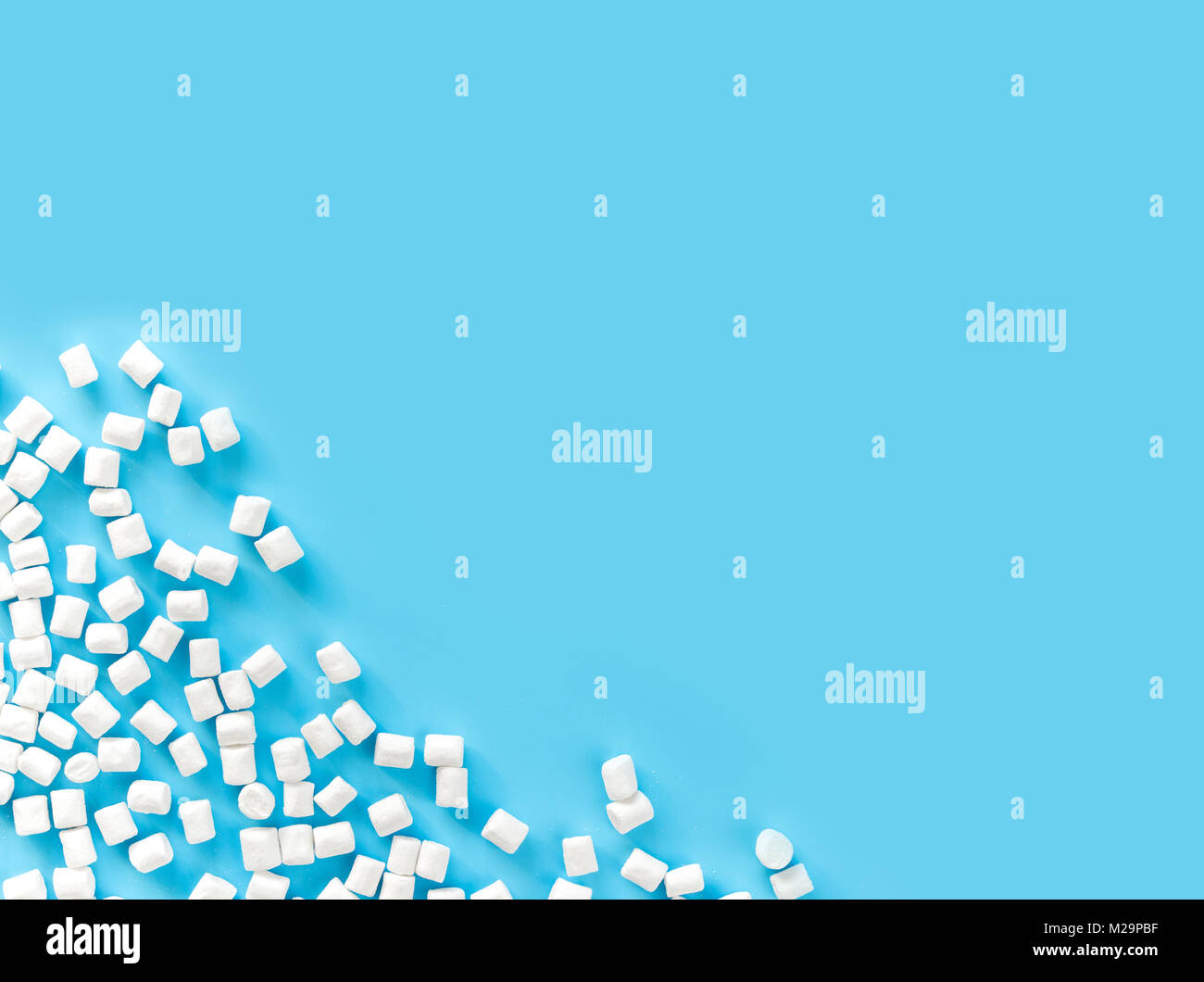 Marshmallows on blue background with copyspace. Flat lay or top view ...