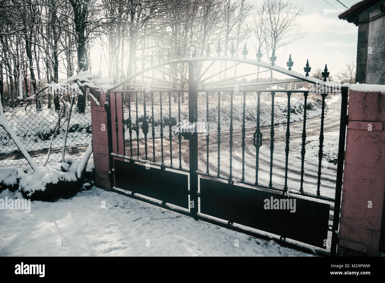 snow forge gate with a path Stock Photo - Alamy