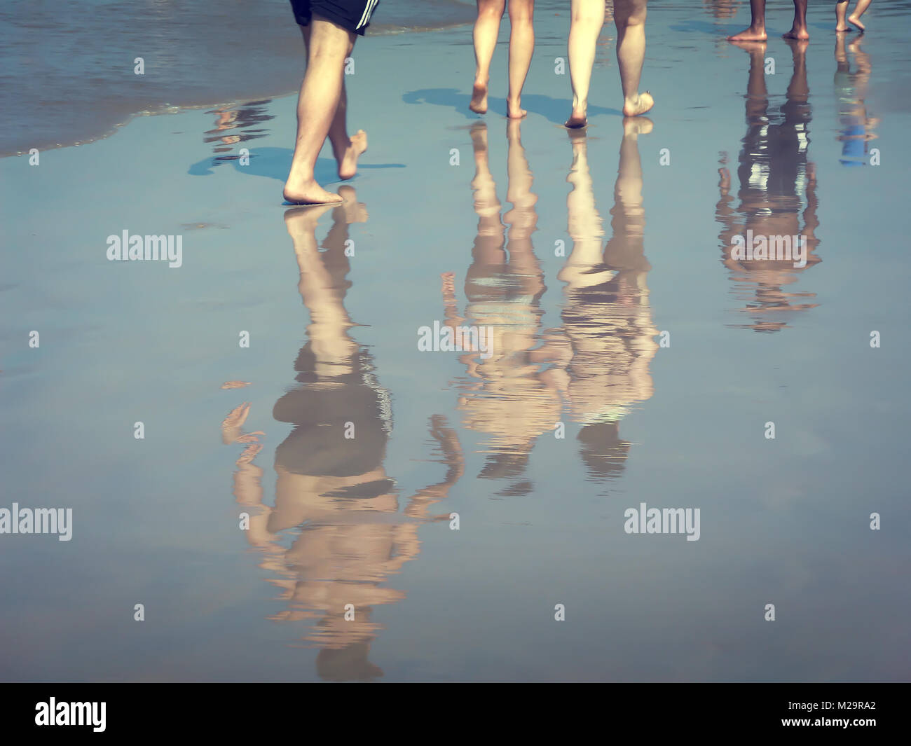 Reflection of people in the wet sand of a beach, vintage style Stock ...
