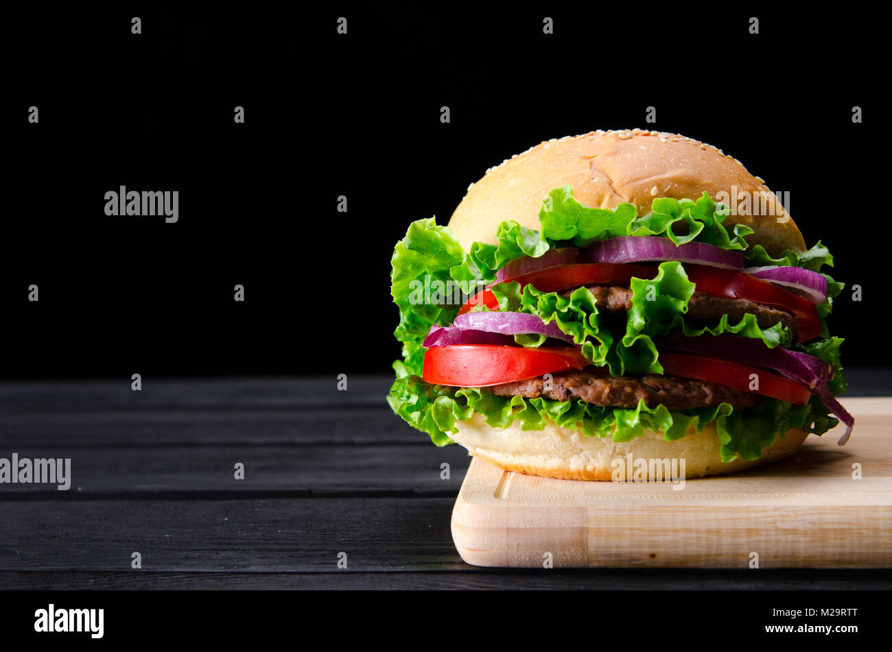Burger served in bun in nutrition fast food concept Stock Photo - Alamy