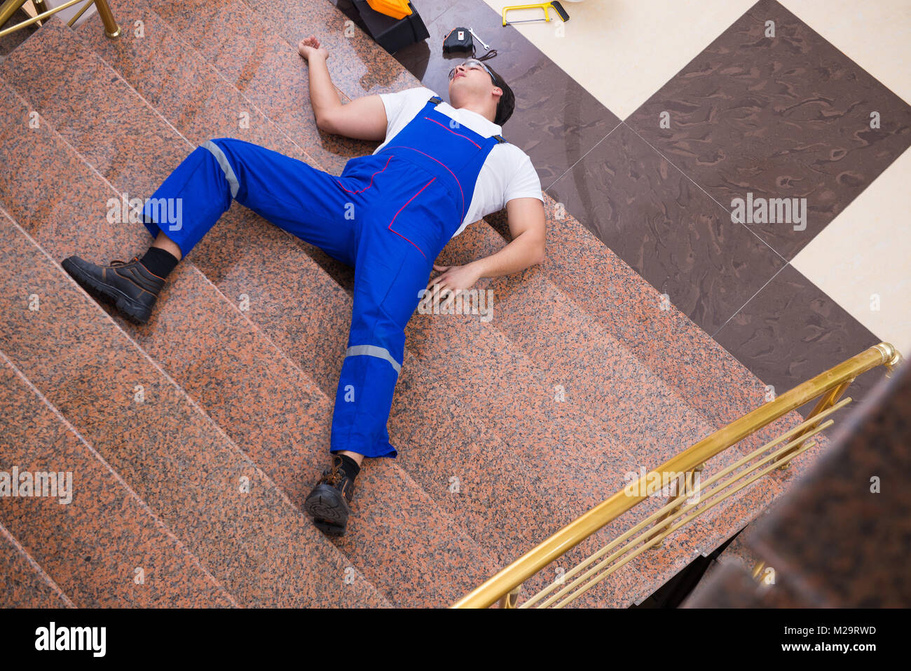 Dead contractor worker felling off the stairs Stock Photo - Alamy