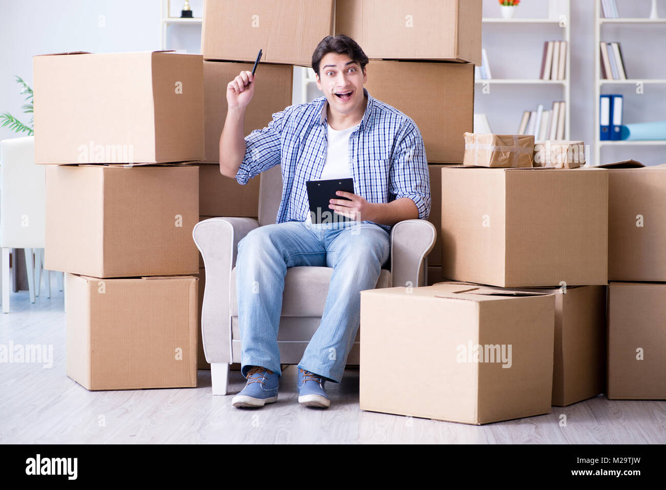 Young man moving in to new house with boxes Stock Photo - Alamy