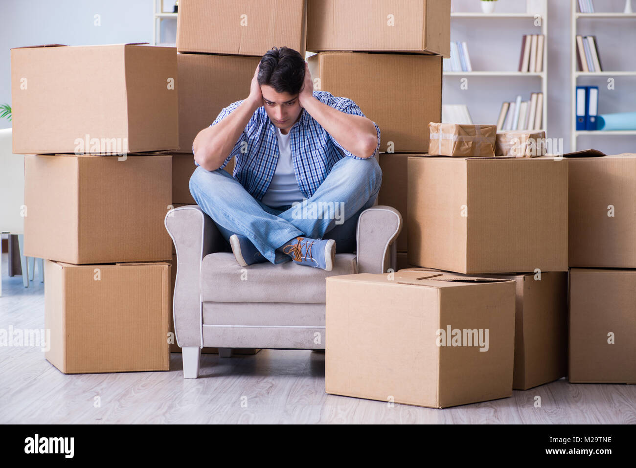 Young man moving in to new house with boxes Stock Photo - Alamy