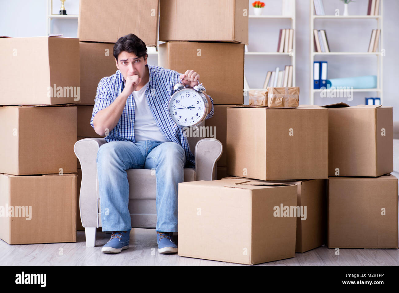 Young man moving in to new house with boxes Stock Photo - Alamy
