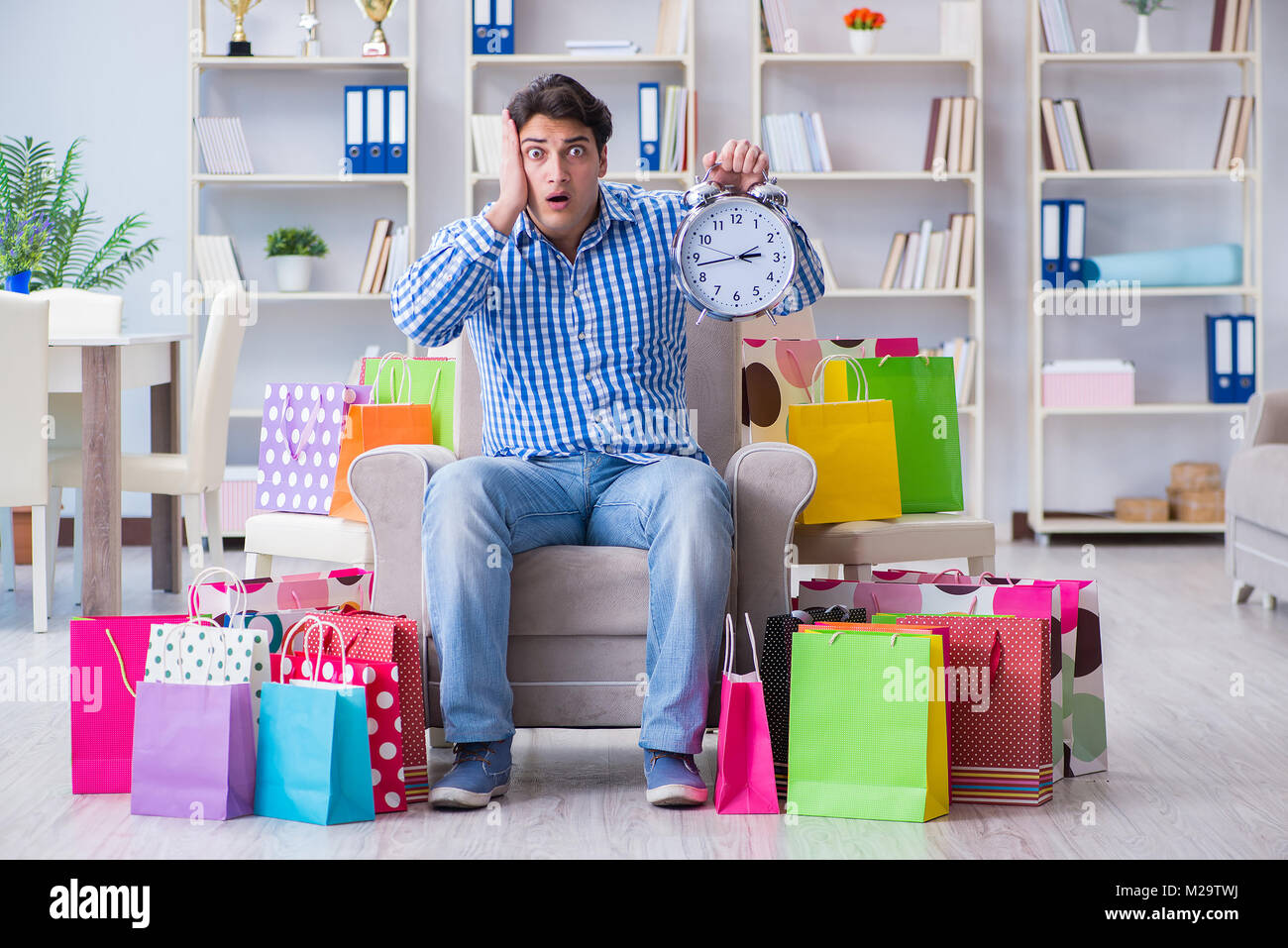 Young man after excessive shopping at home Stock Photo - Alamy