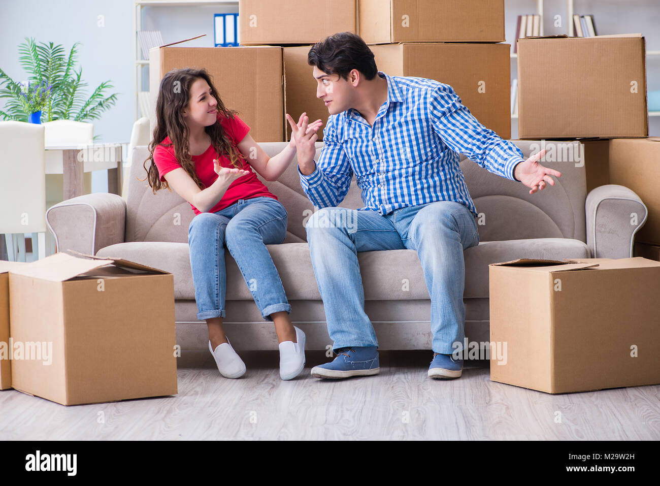 Young pair moving in to new house with boxes Stock Photo - Alamy