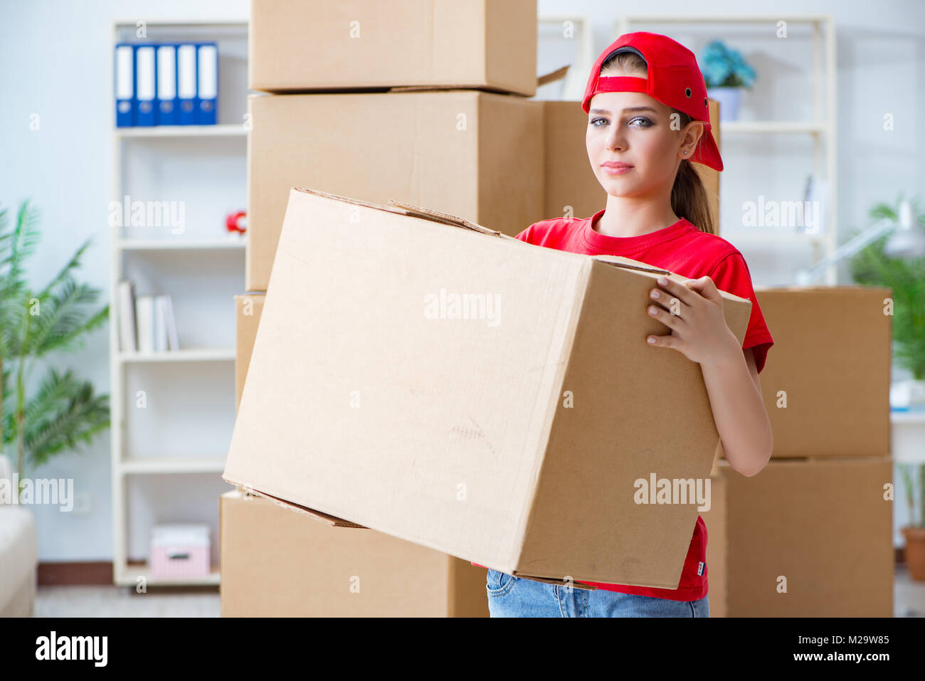 Young woman delivering boxes of personal effects Stock Photo - Alamy