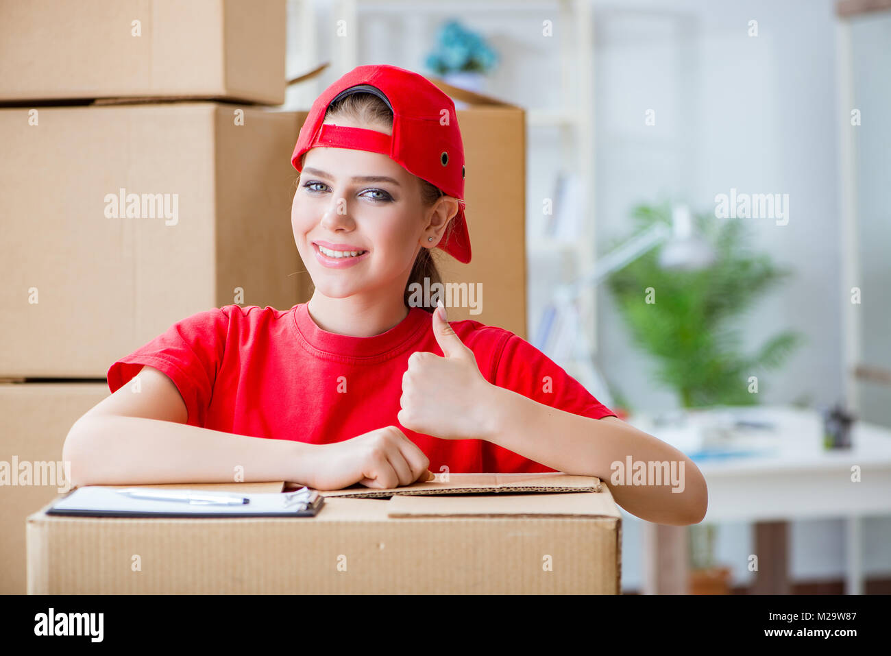 Young woman delivering boxes of personal effects Stock Photo - Alamy