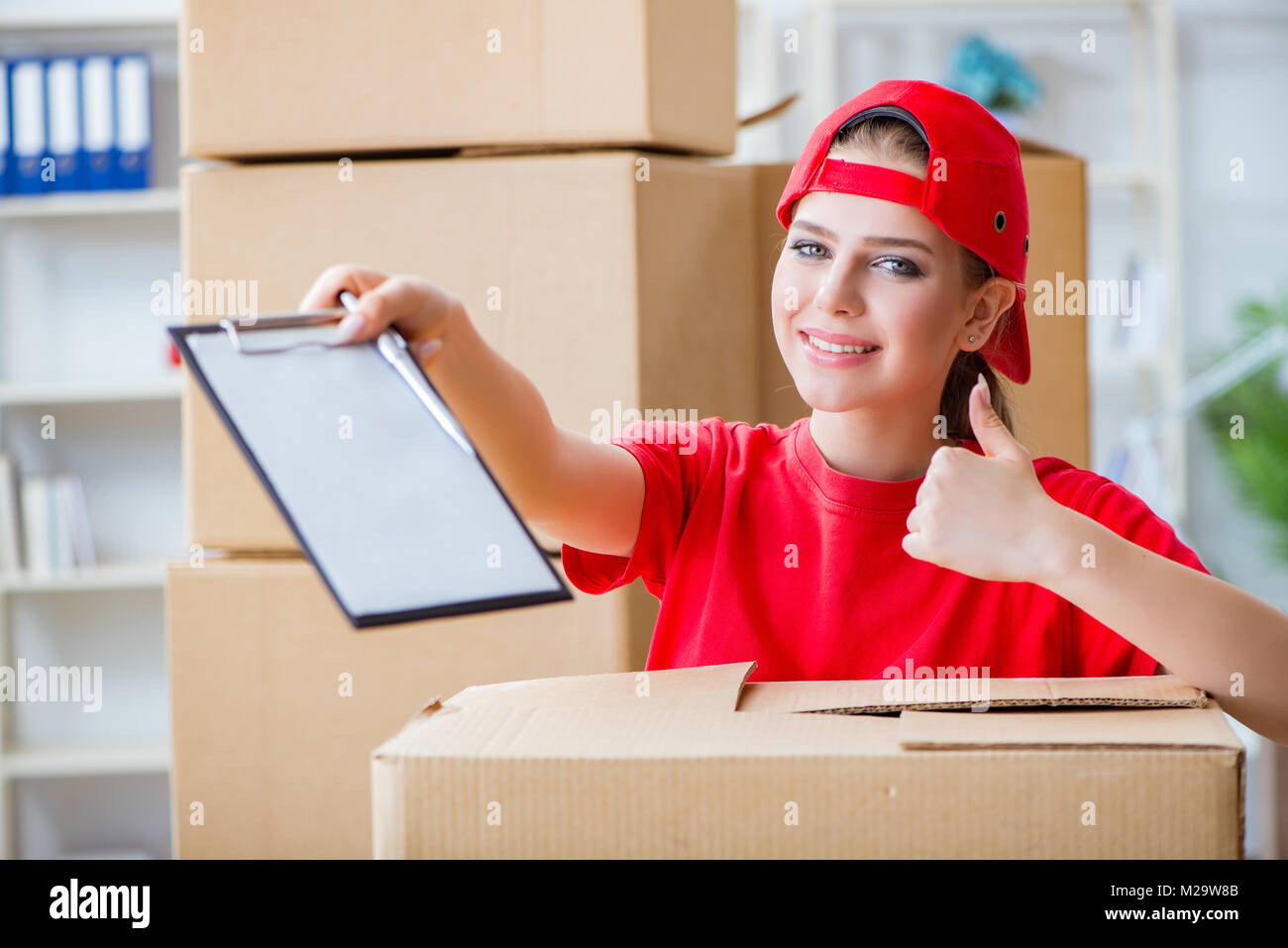 Young woman delivering boxes of personal effects Stock Photo - Alamy