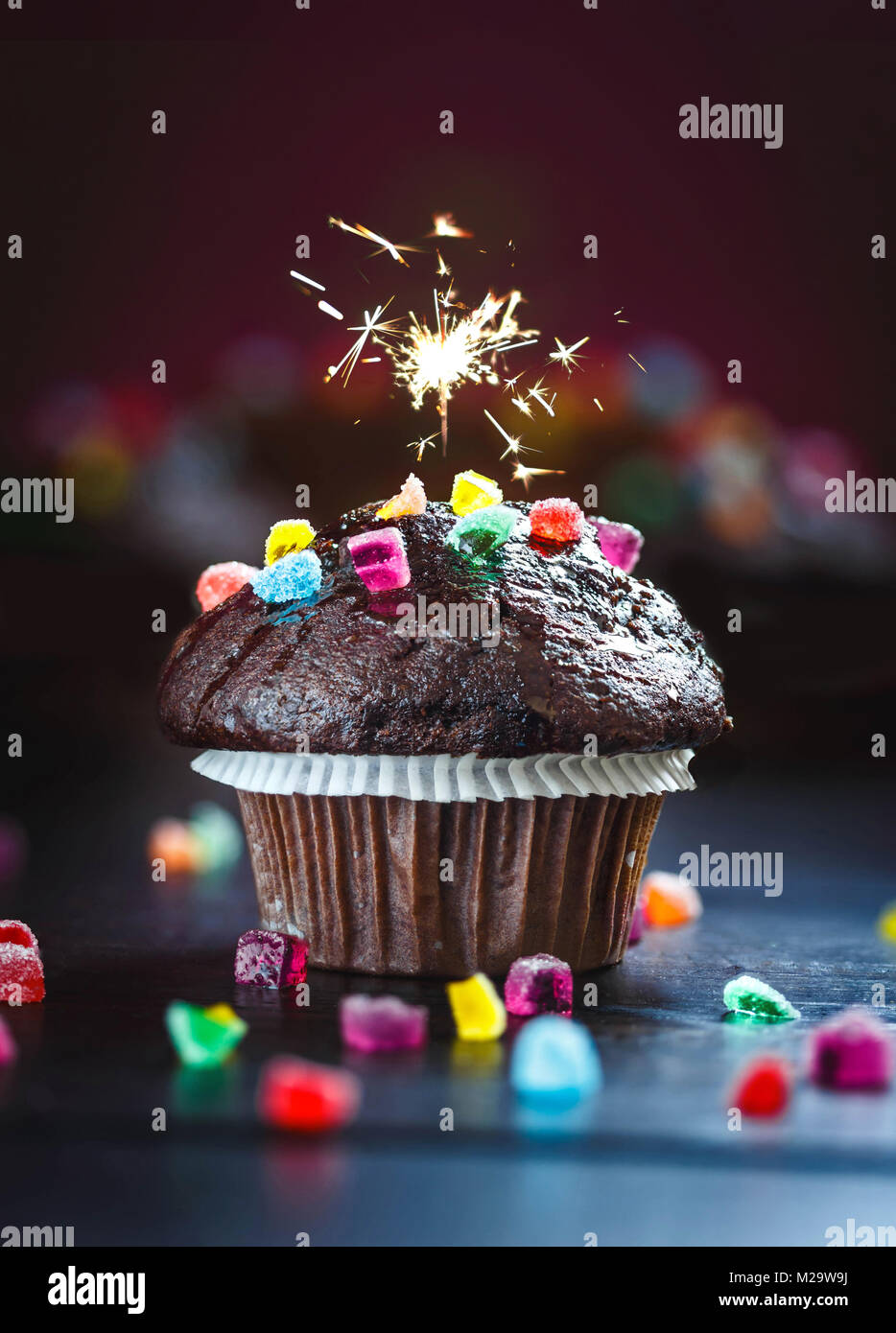 Delicious and funny Chocolate Muffin with candies and sparkler on ...