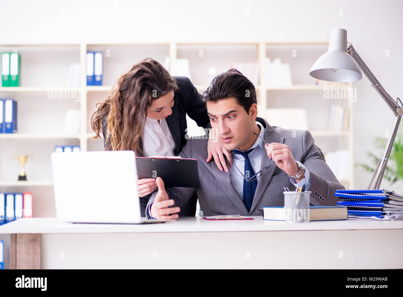 Unhappy boss having a chat with his secretary Stock Photo - Alamy
