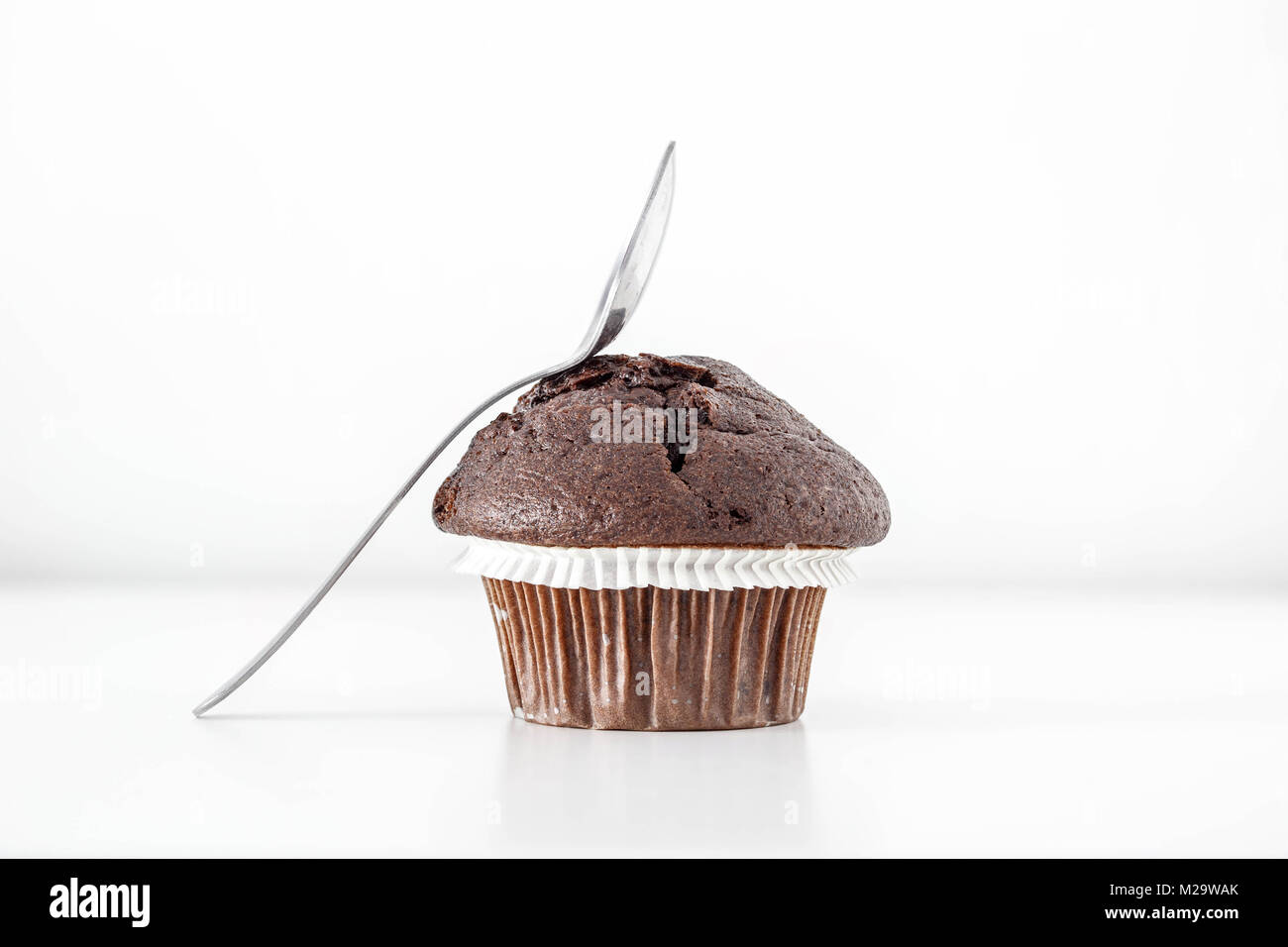 Fresh baked Chocolate Muffin on white background. Frontal view. Copy ...