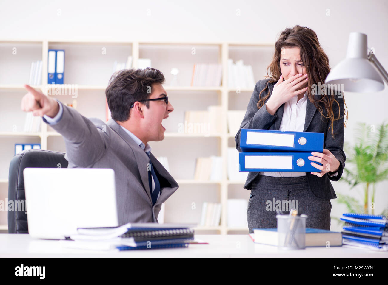 Angry boss unhappy with female employee performance Stock Photo - Alamy