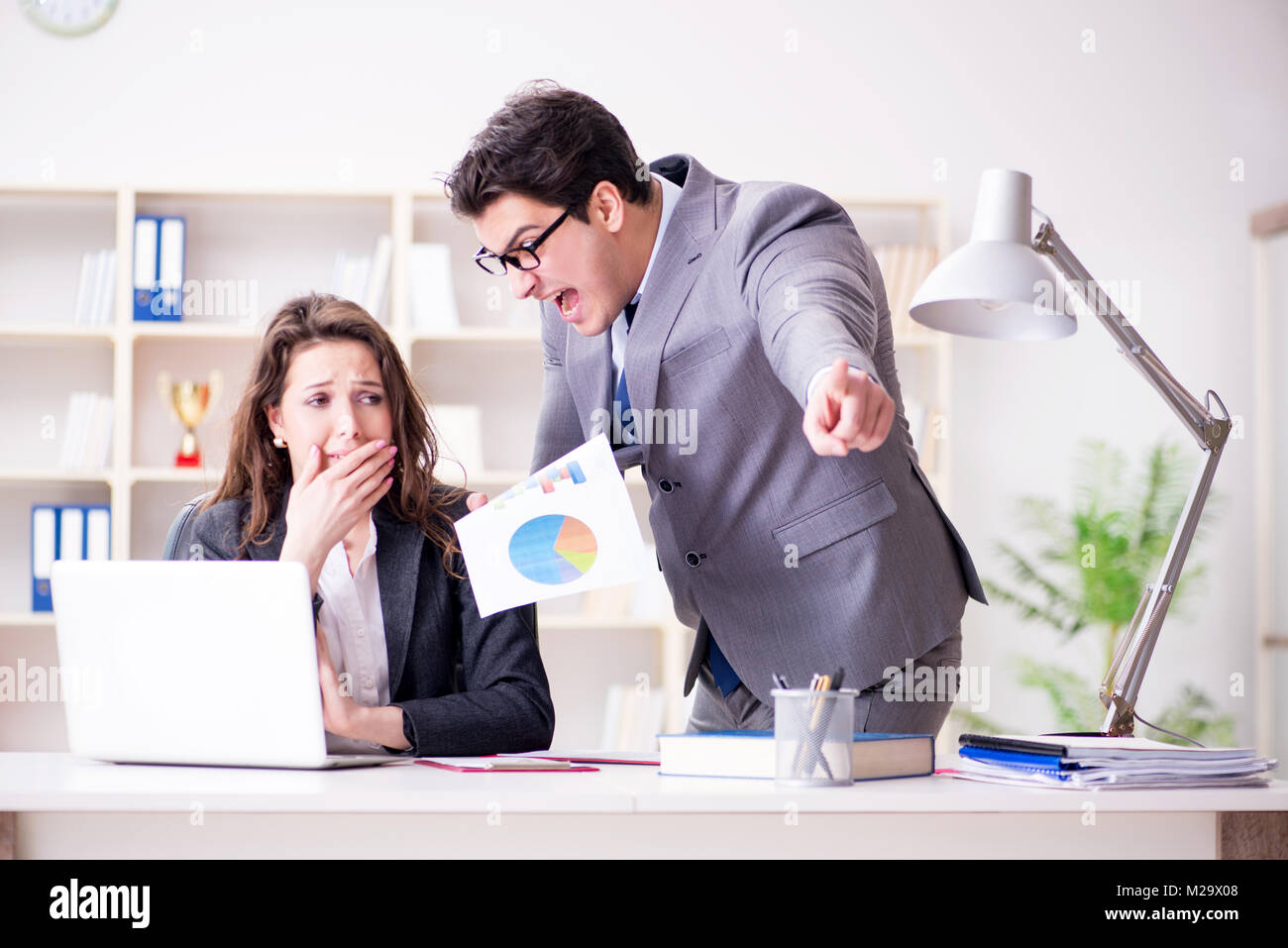 Angry boss unhappy with female employee performance Stock Photo - Alamy