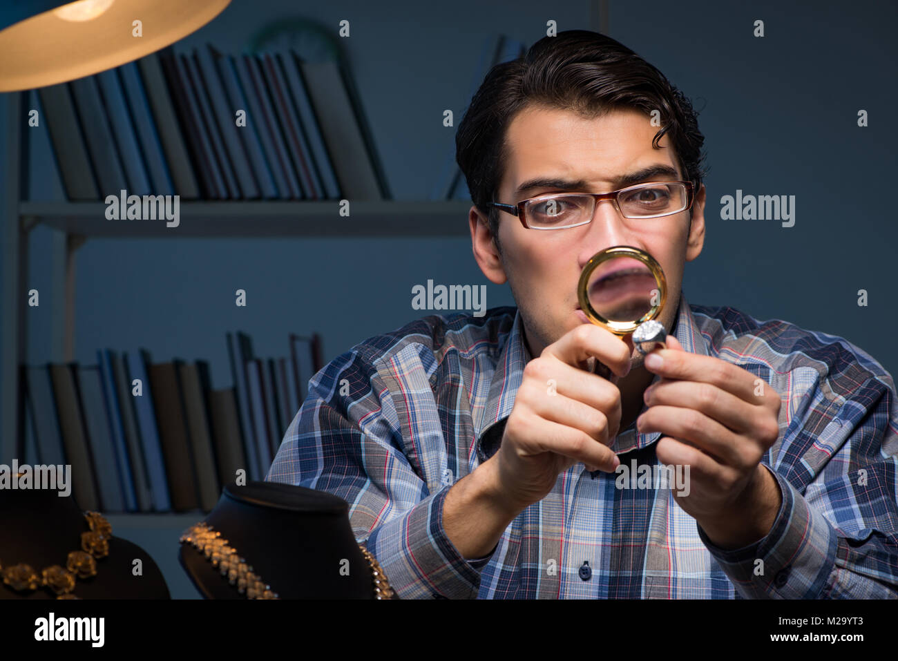 Jeweller examining ring hi-res stock photography and images - Alamy