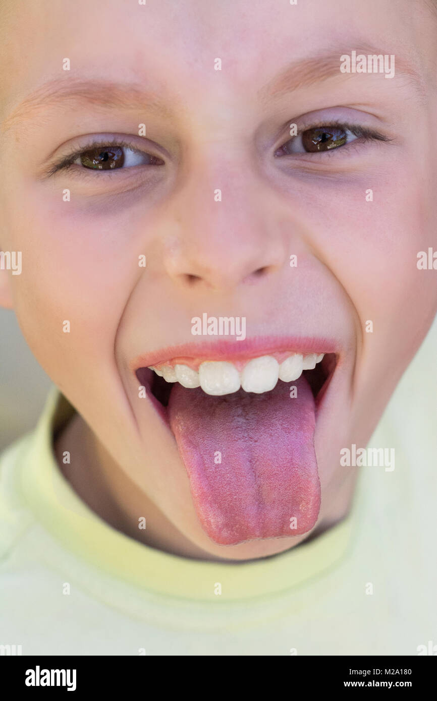 The Ukrainian boy laughs, shows the tongue and teeth on the camera ...