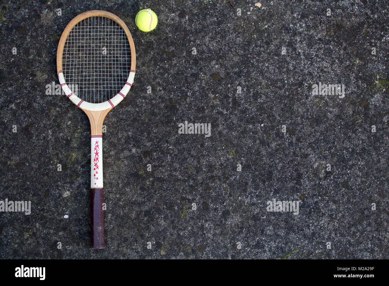 Old vintage wooden tennis racket on isolated stone background with ...
