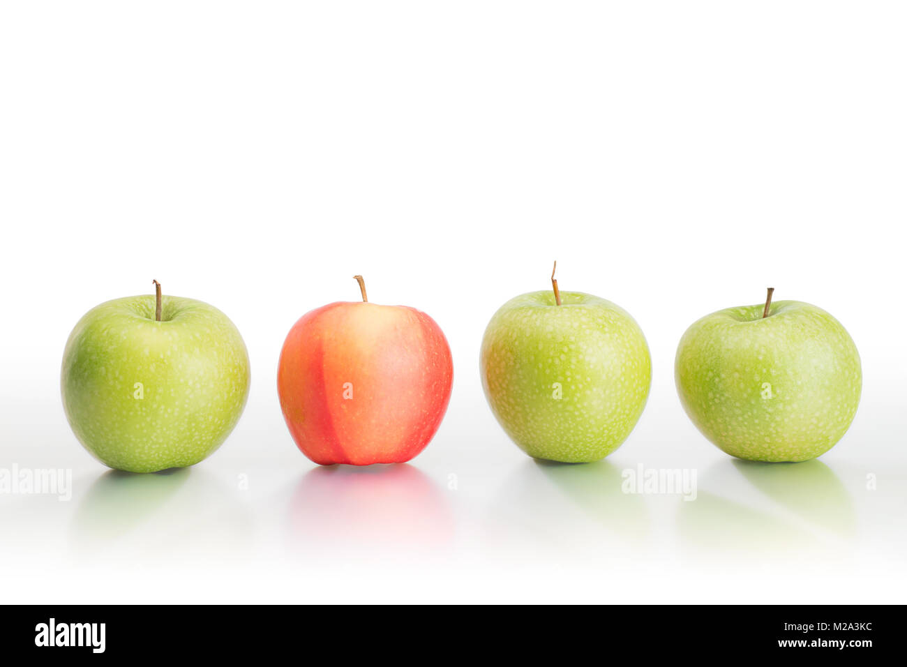 Four large fresh apples in the row: one red and three green. Isolated ...
