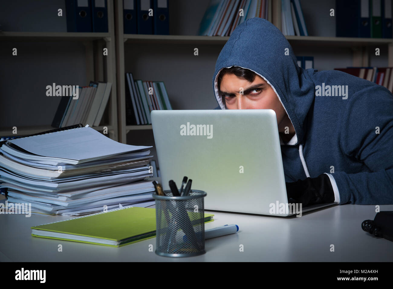 Young hacker hacking into computer at night Stock Photo - Alamy
