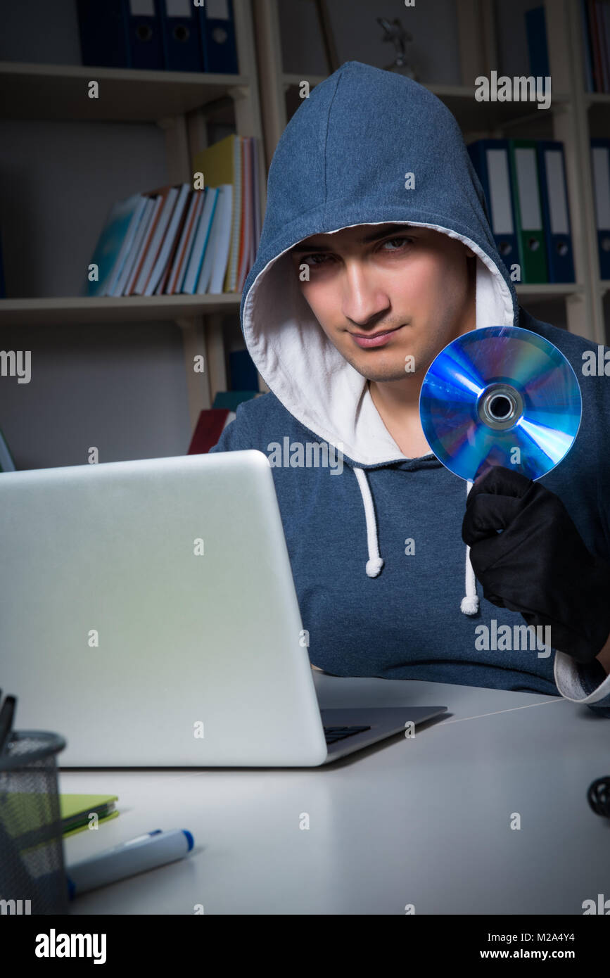 Young hacker hacking into computer at night Stock Photo - Alamy