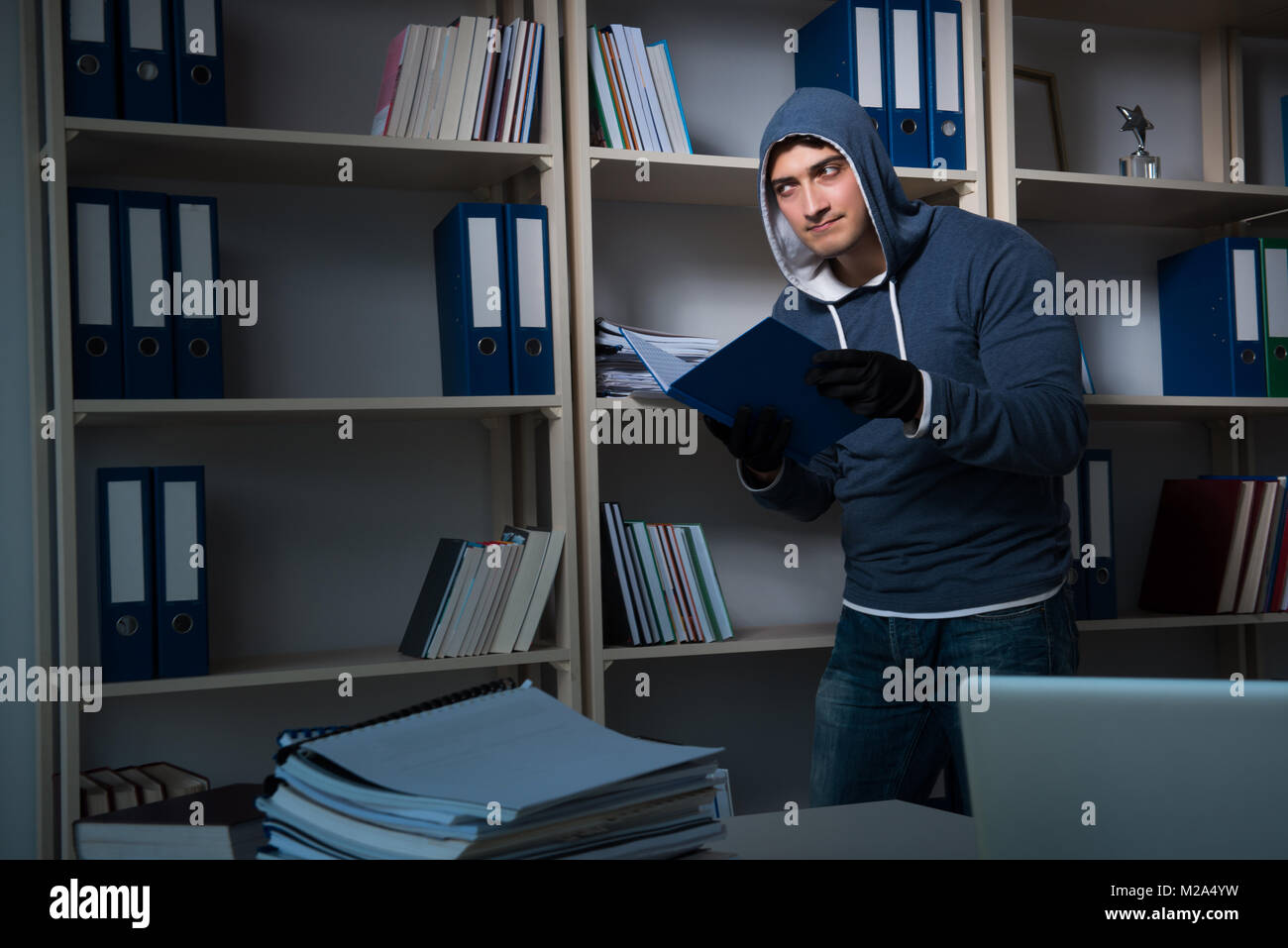 Young man in industrial espionage concept Stock Photo - Alamy