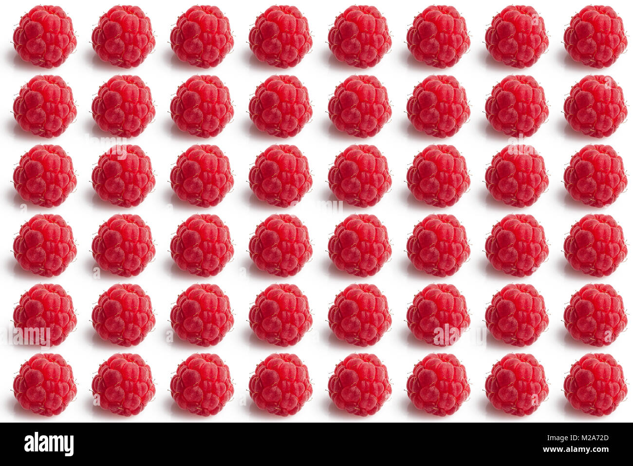 Small raspberries arranged in symmetric pattern on white background ...