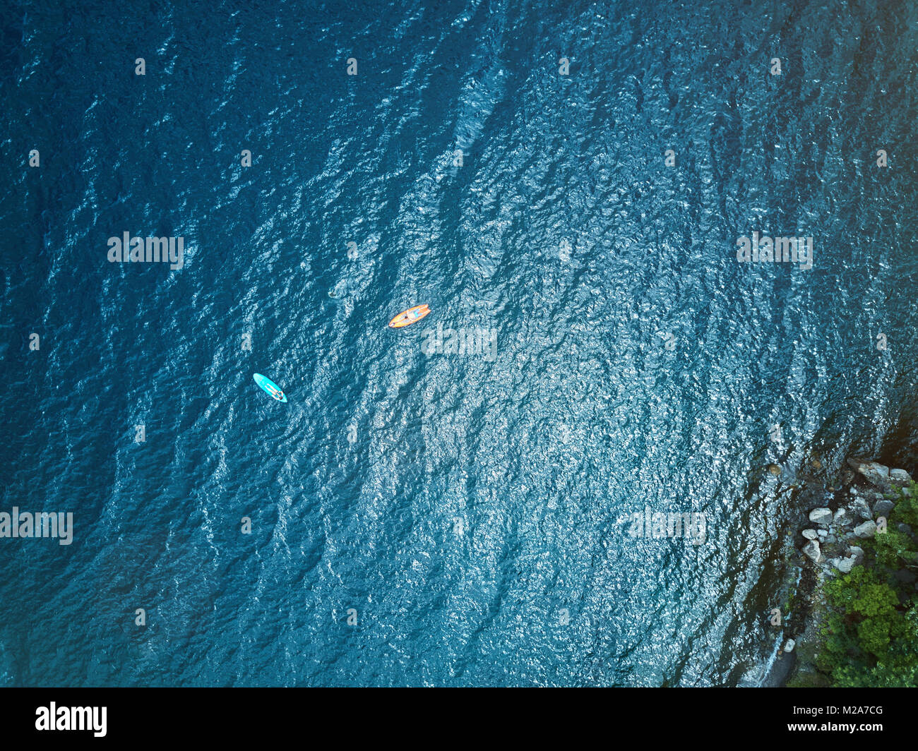 Two colorful kayak in blue lagoon water above aerial view Stock Photo ...