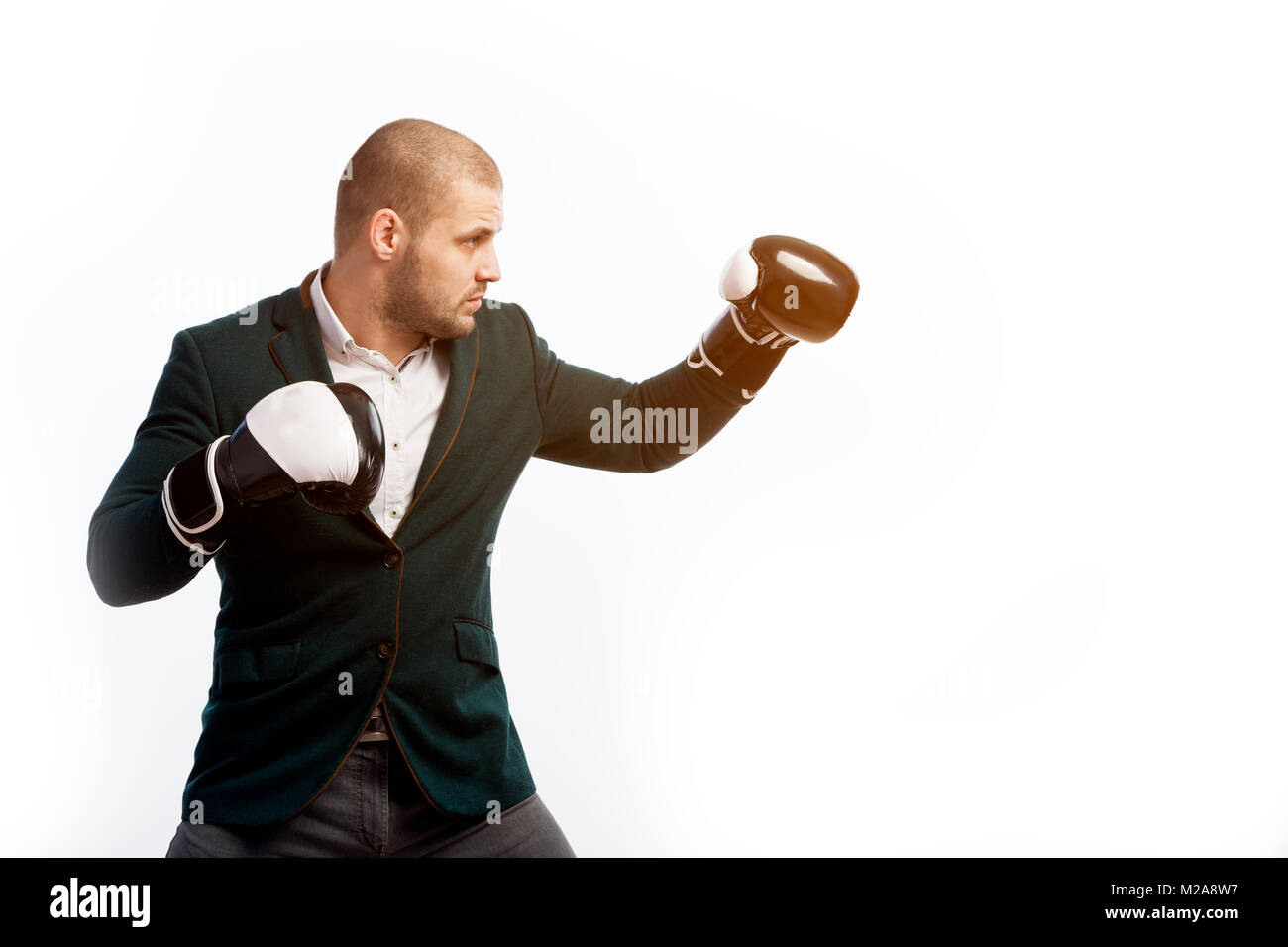 Young bald man, confident manager in white shirt, green suit and boxing ...