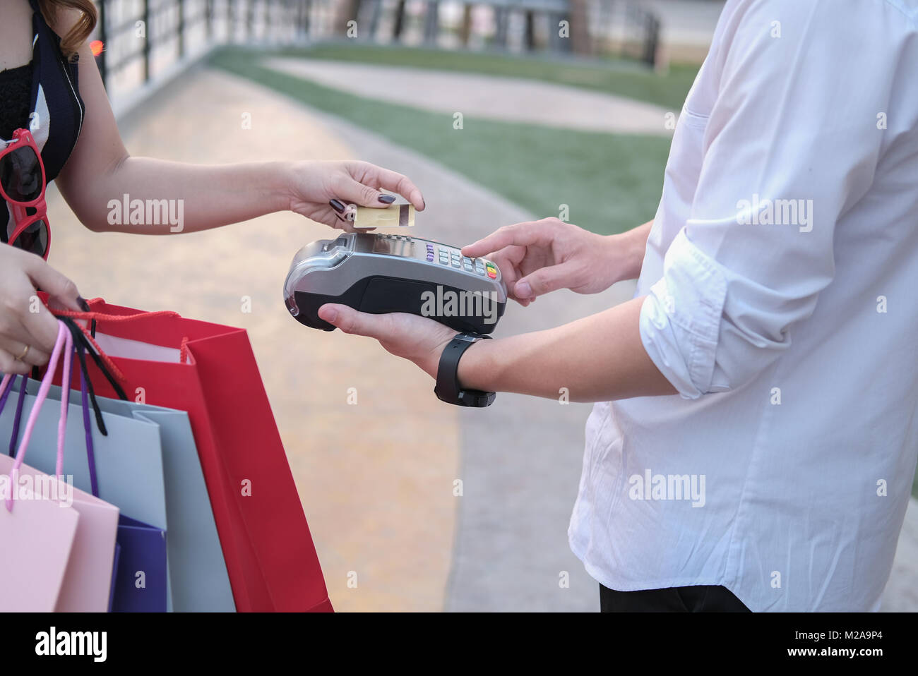 man make payment with credit card swipe through terminal. customer ...