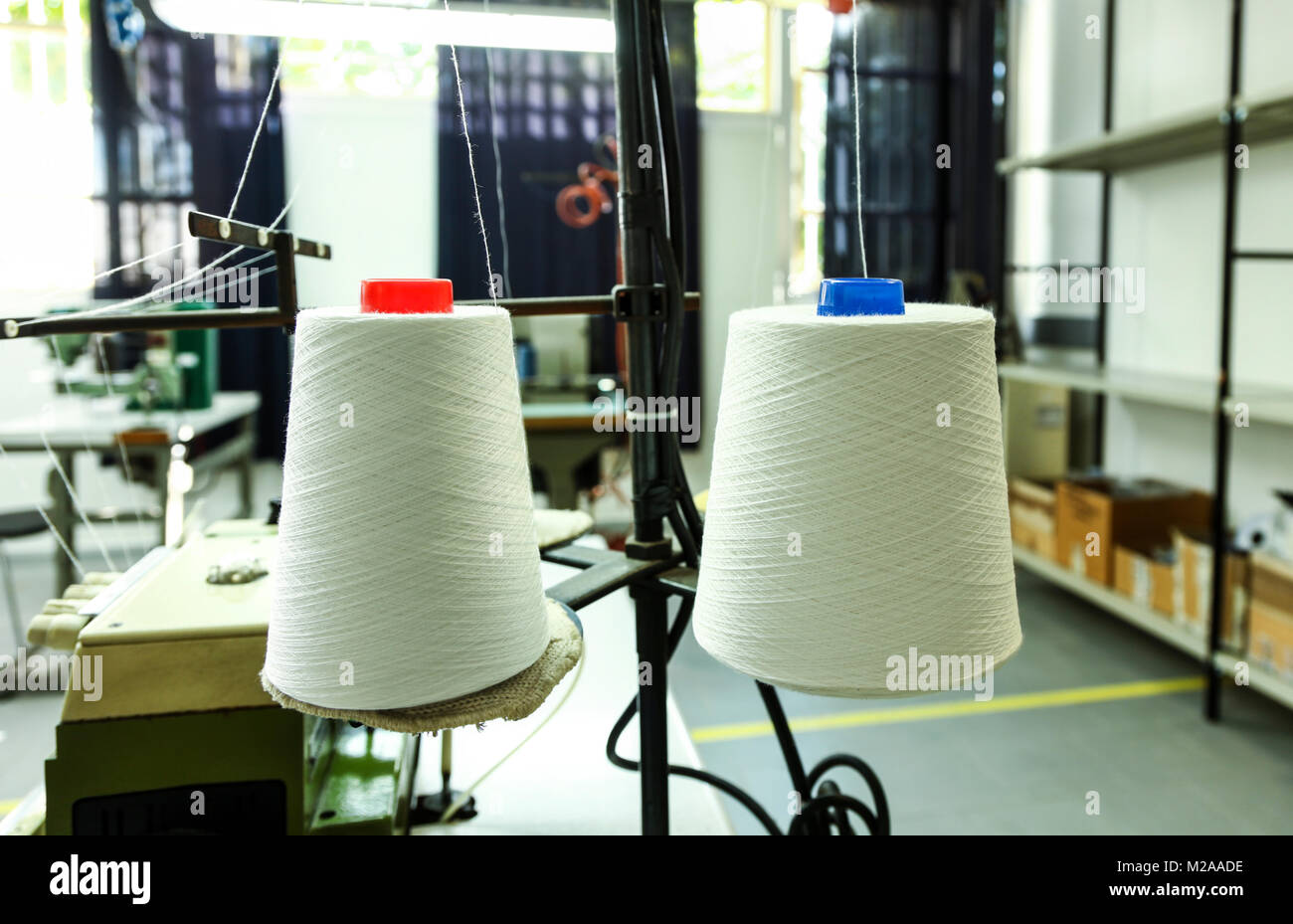 Industrial textile factory, two bobbins Stock Photo - Alamy