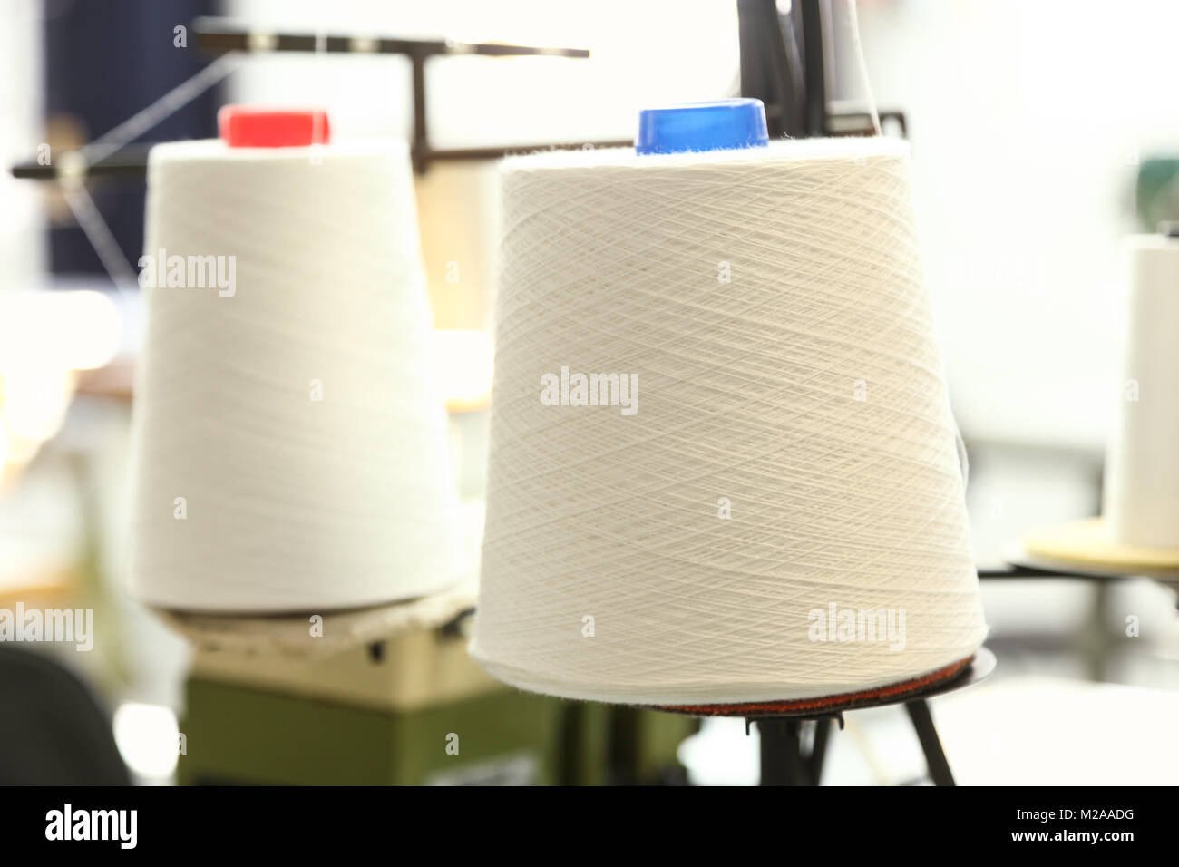 Industrial textile factory, two bobbins Stock Photo - Alamy