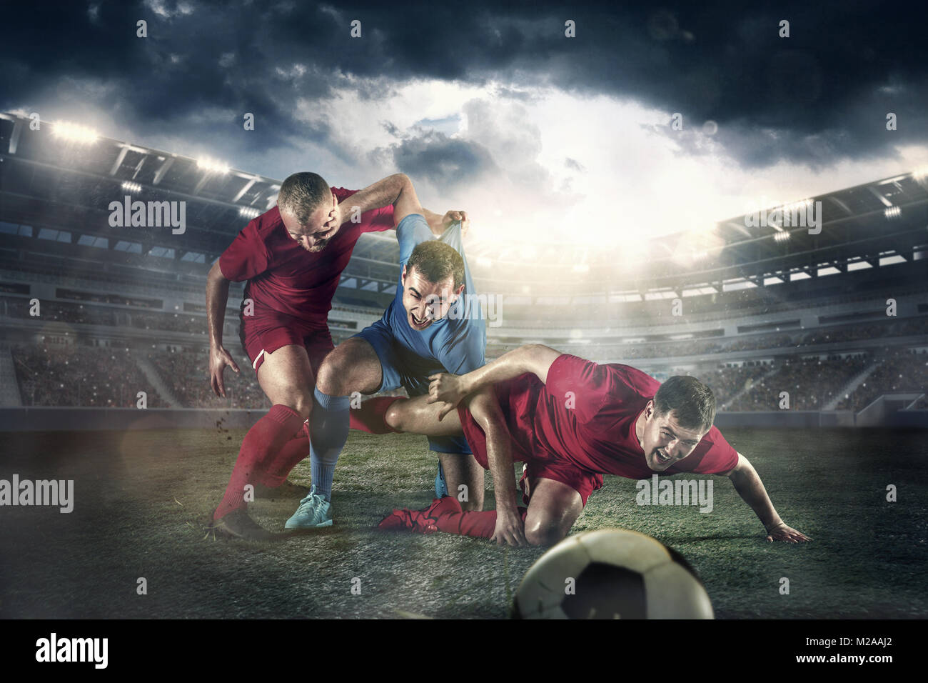 The football player in motion on the field of stadium Stock Photo - Alamy