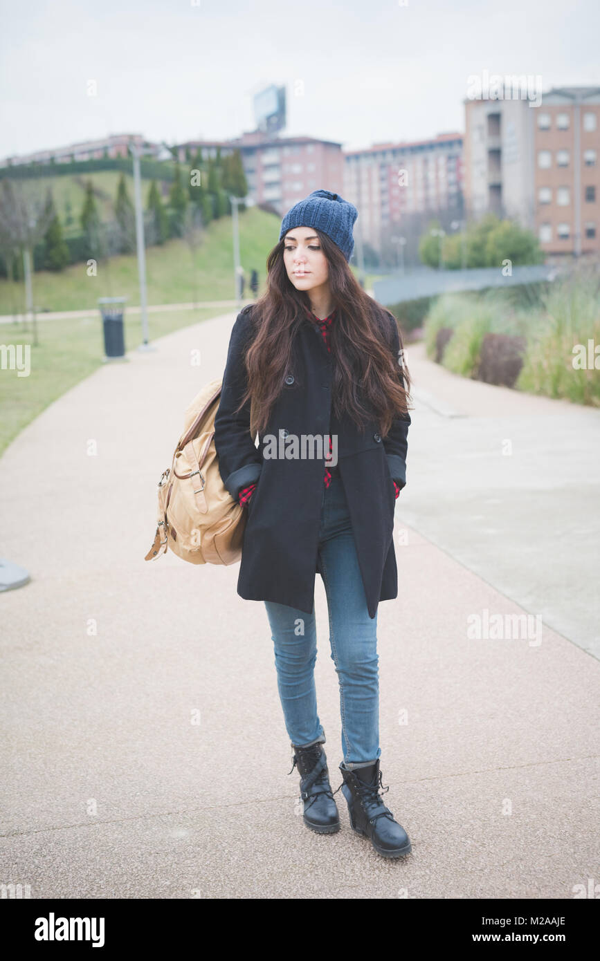 young beautiful woman walking outdoor looking down hopeful - pensive ...