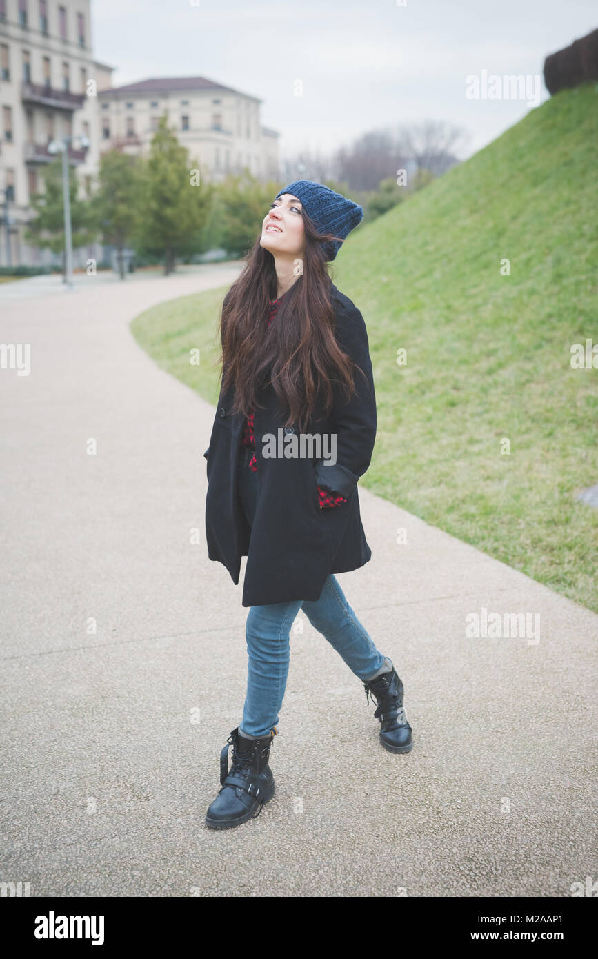 young woman walking outdoor having fun - toothy smile, getting away ...