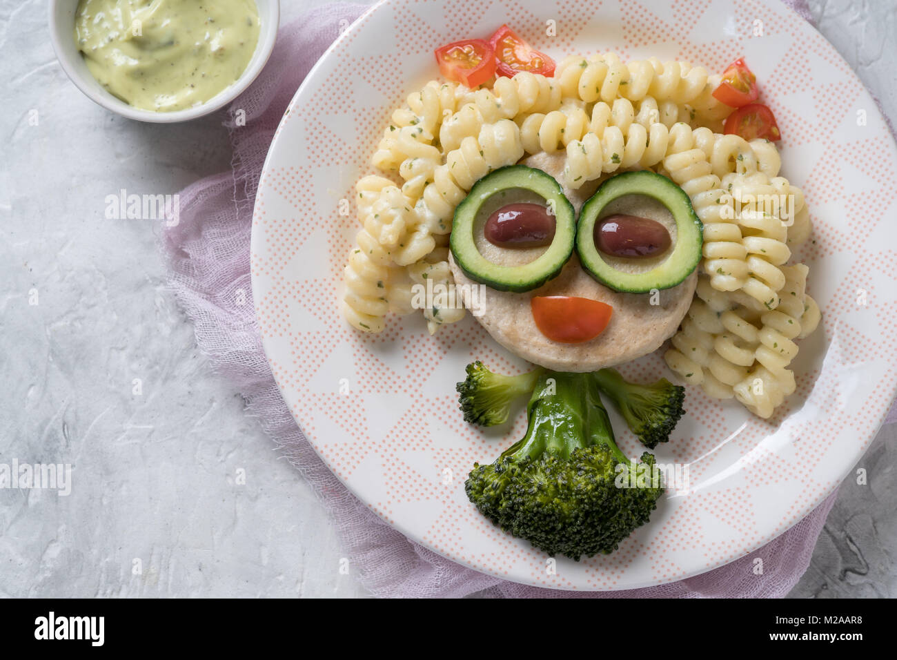 Funny Girl Food Face with chicken Cutlet, Pasta and Vegetables Stock ...